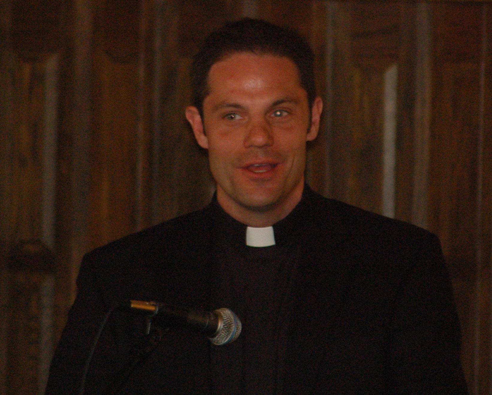 Fr. Tom Burke, Co-Director of Vocations, accepts the
